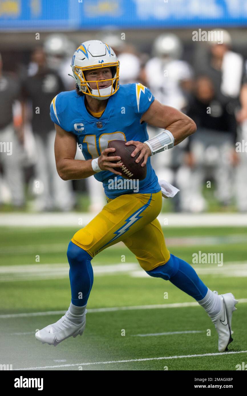 Los Angeles Chargers quarterback Justin Herbert (10) rolls out to pass ...