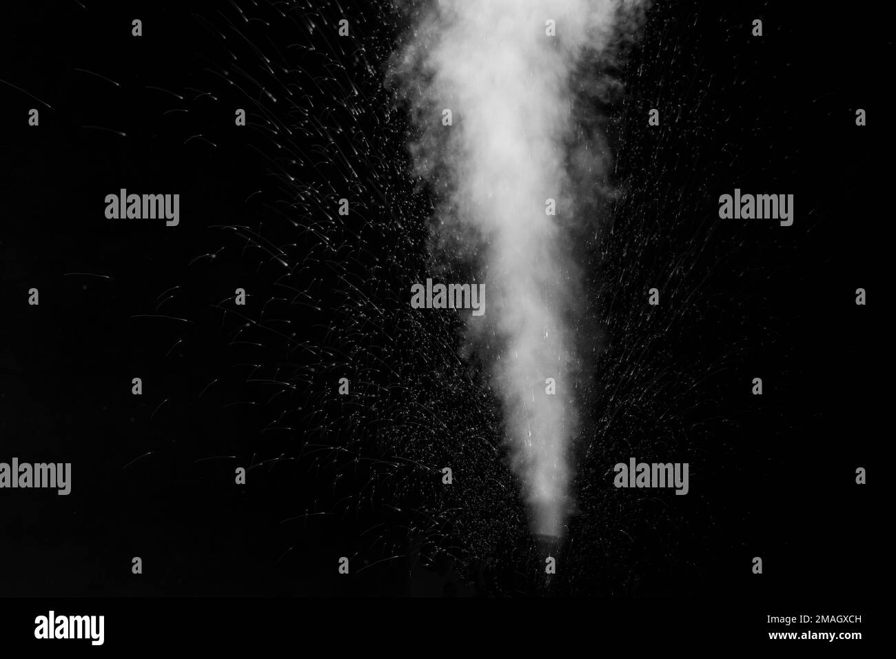 A jet of white water vapor with splashes of water from the humidifier ...