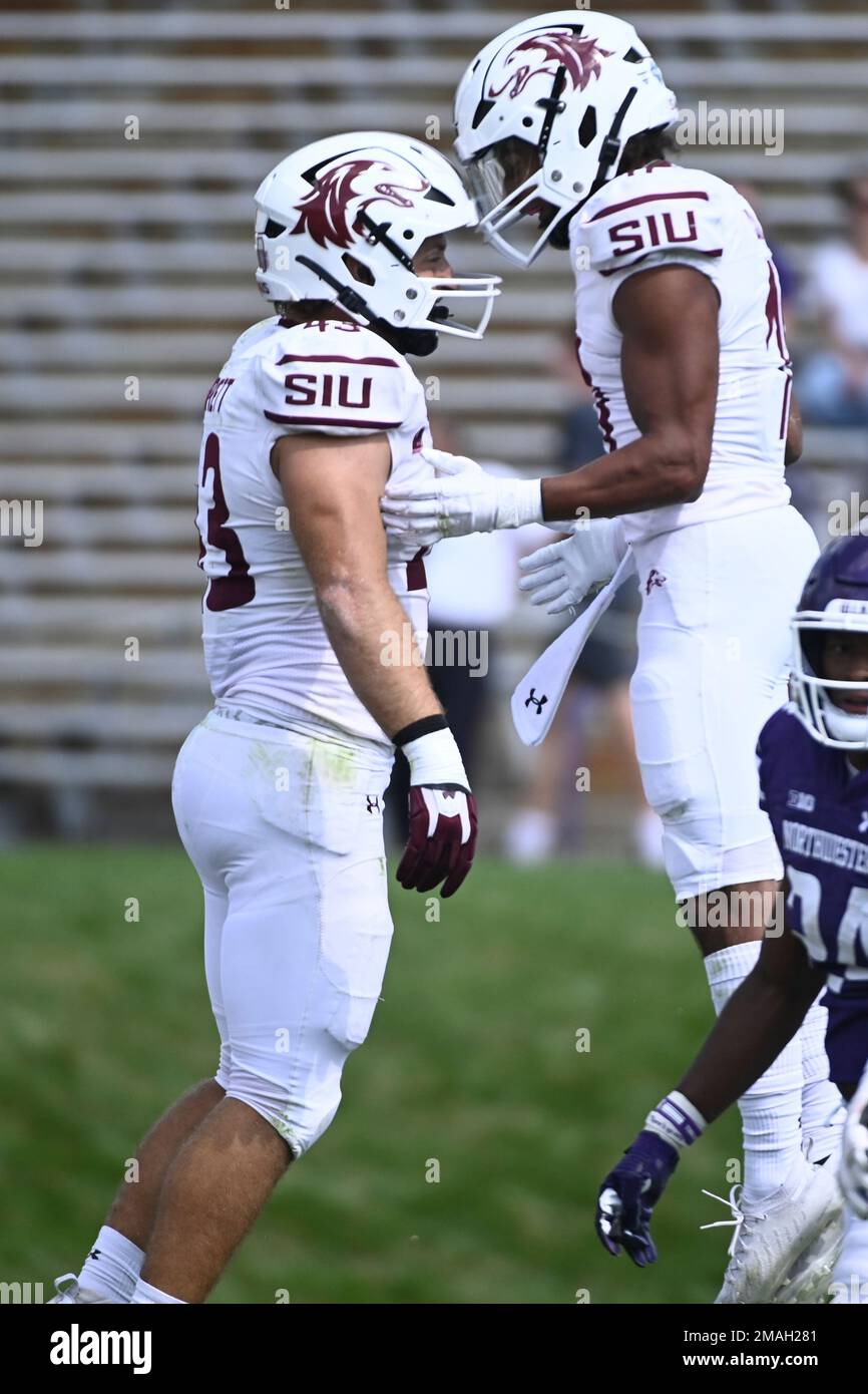 Southern Illinois fullback Jacob Garrett, left, celebrates his ...