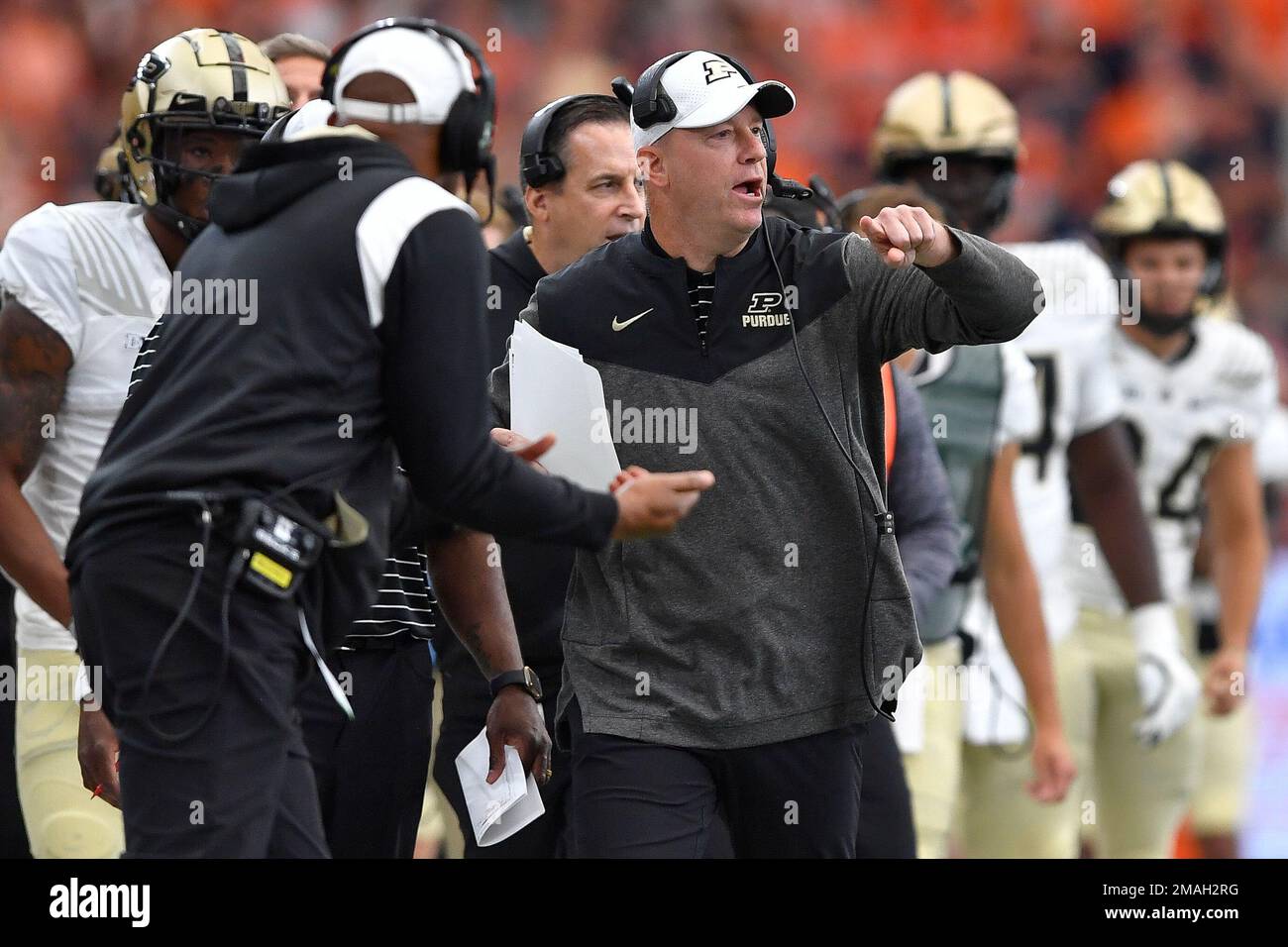 Purdue head coach Jeff Brohm, center, calls a play during the first ...