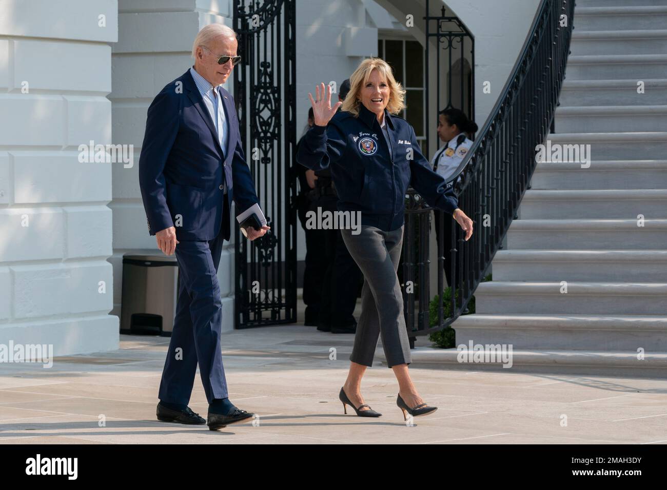 First lady Jill Biden waves as she and President Joe Biden walk to ...