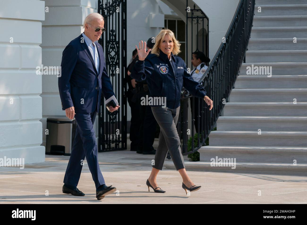 First lady Jill Biden waves as she and President Joe Biden walk to ...