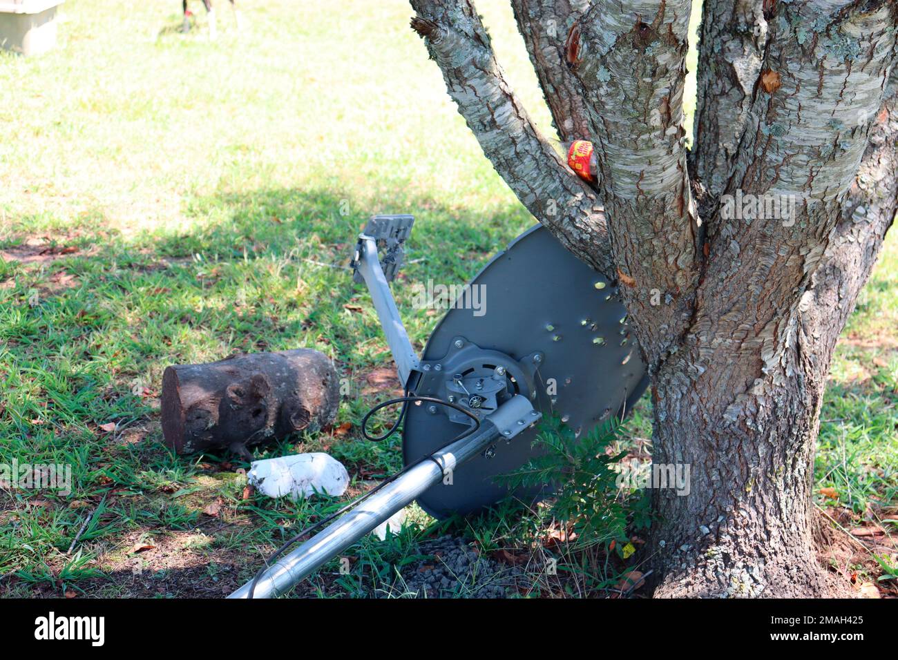 Bullet holes line the fallen satellite dish that officials say Nicholas ...
