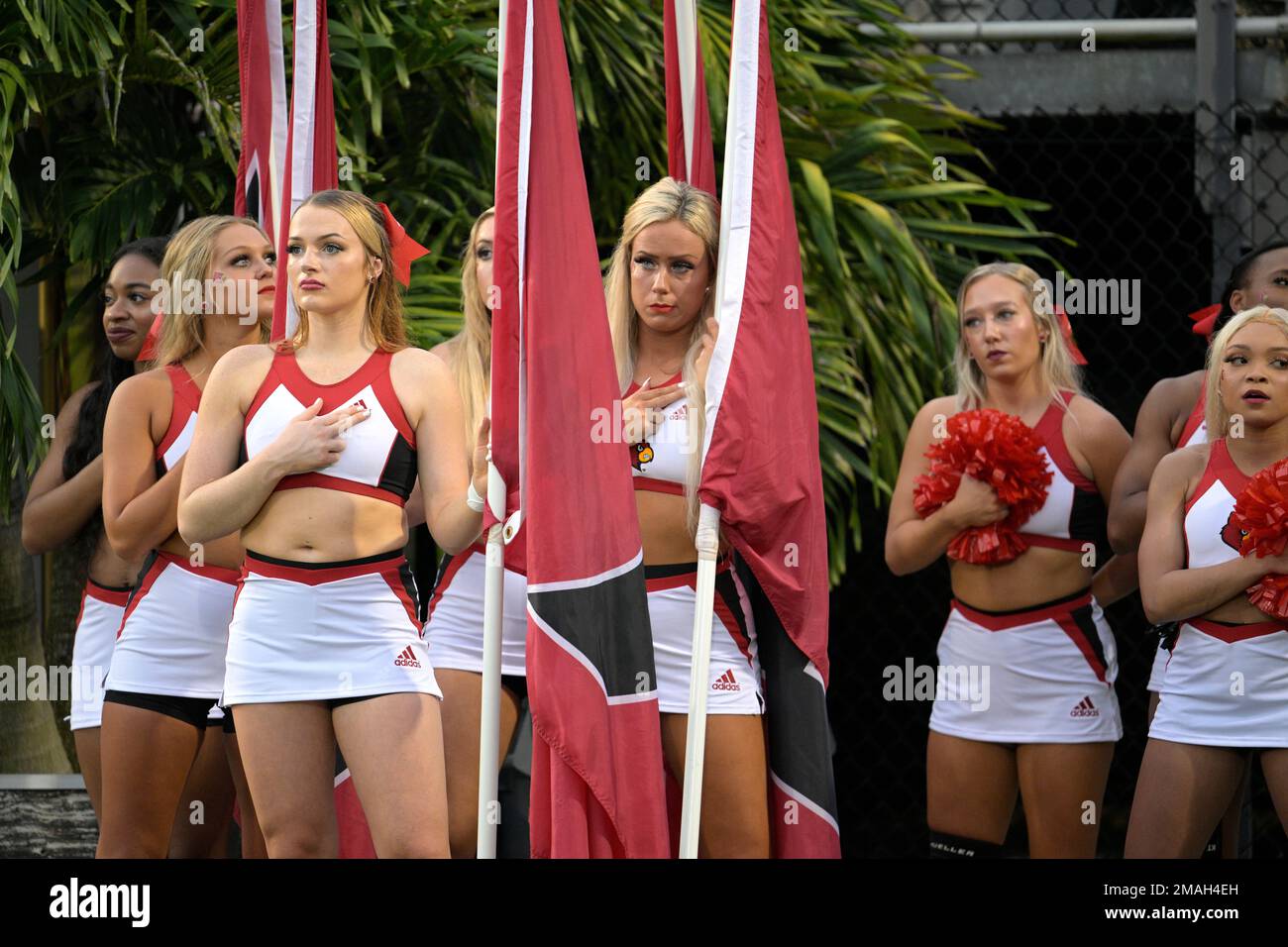 Louisville cheerleaders stand for the national anthem before an NCAA ...