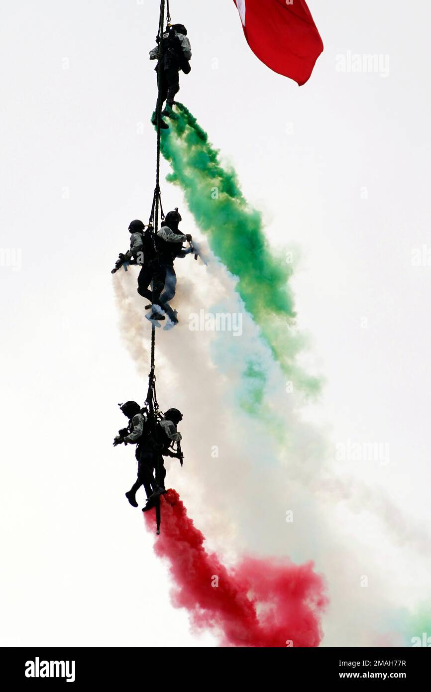 Special forces hang from a helicopter with billowing smoke in the ...
