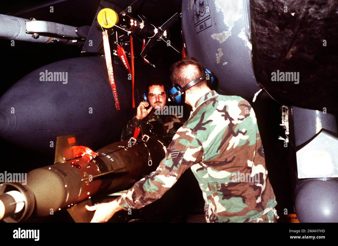 US Air Force weapon loaders load an AGM-123 Skipper air to surface ...