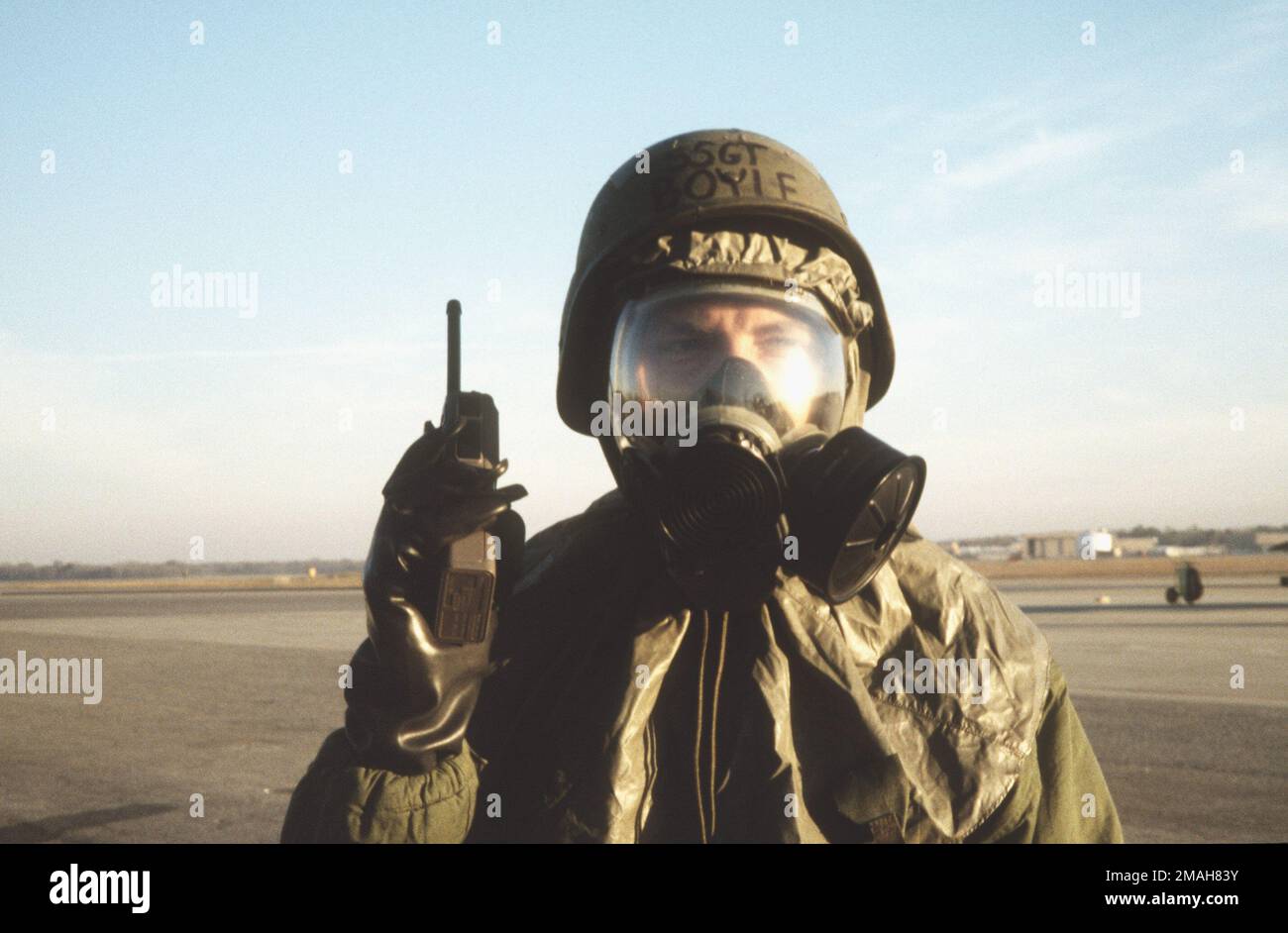 STAFF SGT. Barry Boyle, dressed in full chemical warfare gear, uses a ...