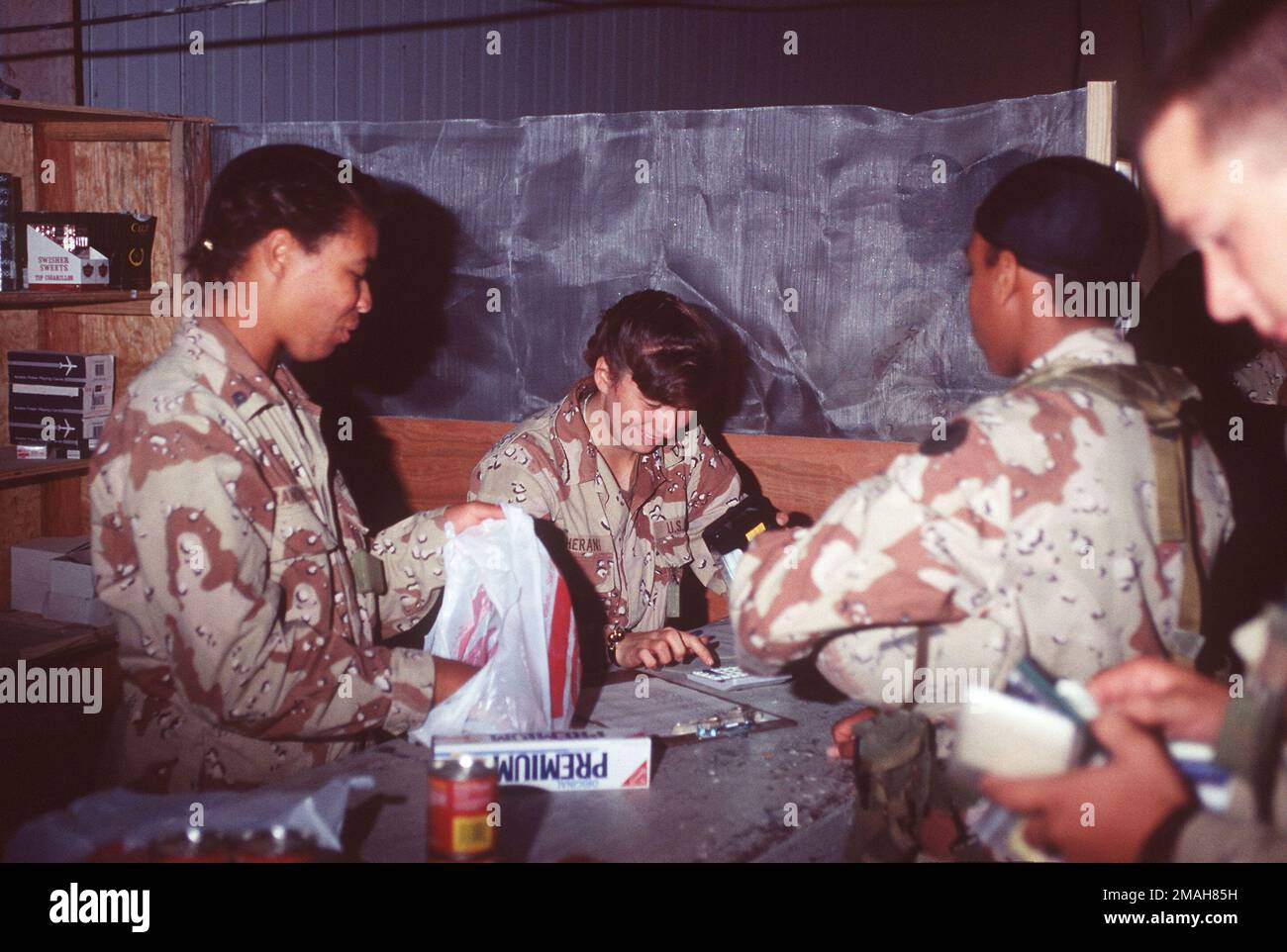 U.S. Army personnel, from the 24th Infantry Division work the registers ...
