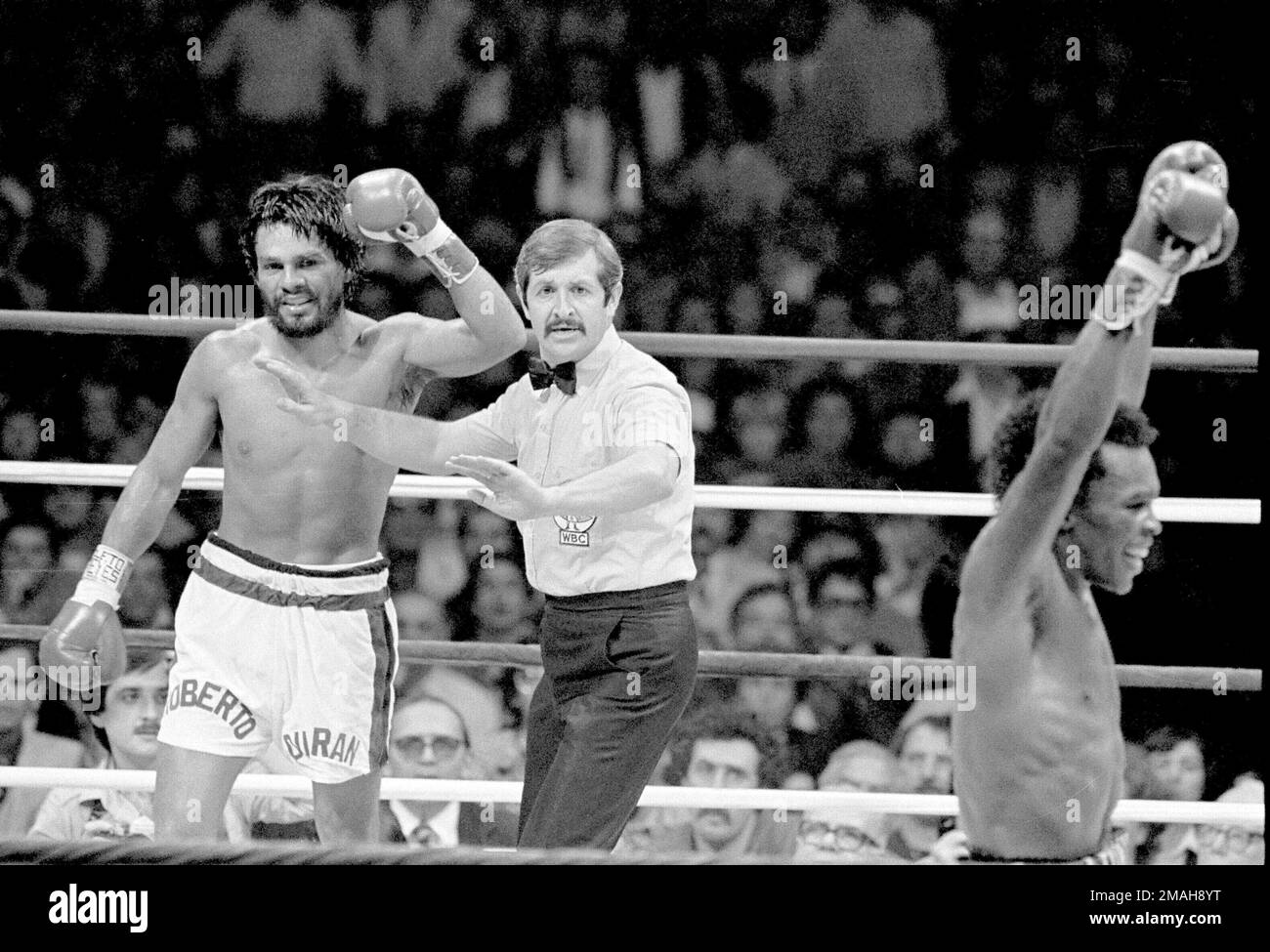 FILE- Sugar Ray Leonard, right, raises his arms in victory as Roberto ...