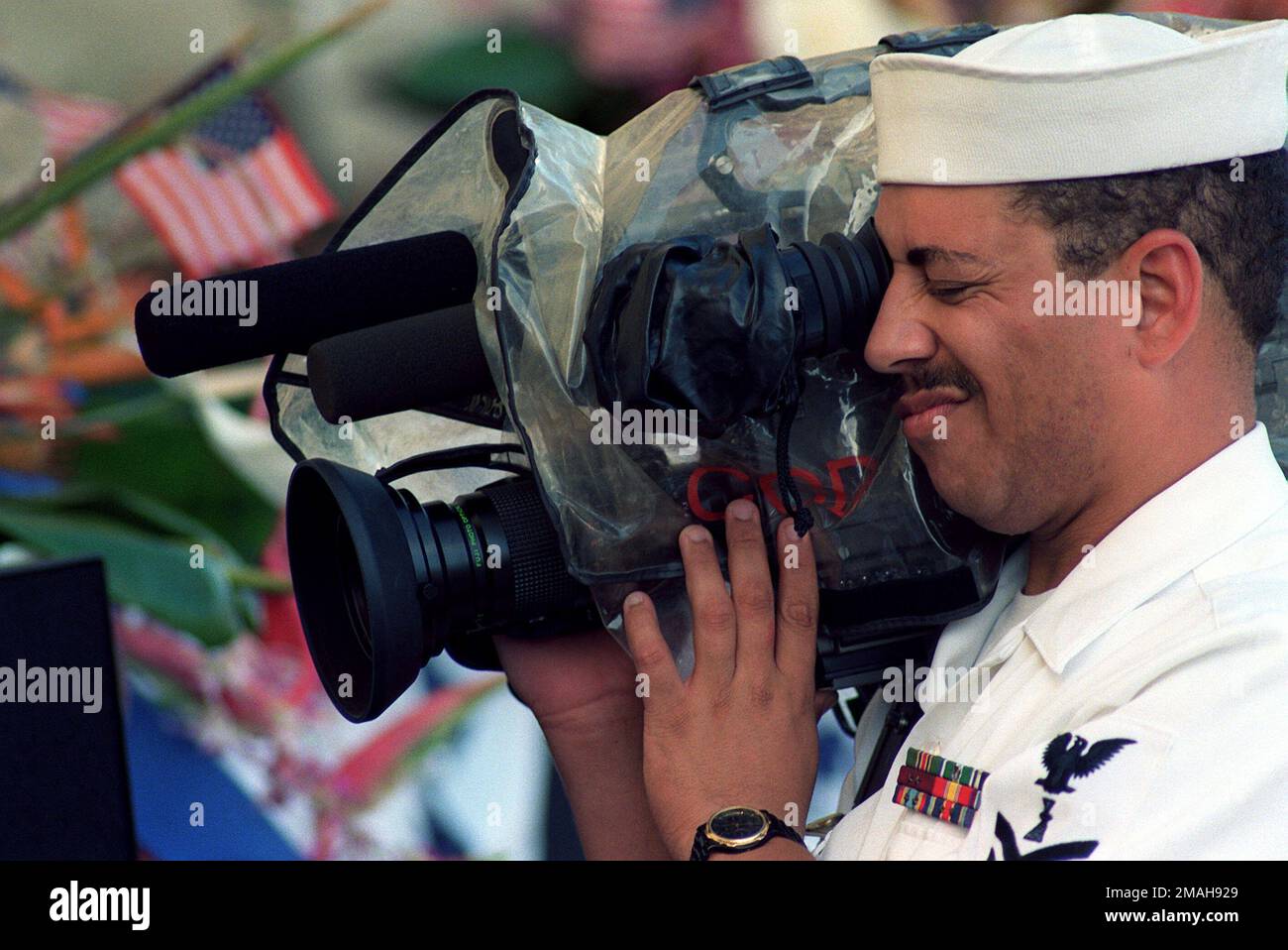 A member of the Fleet Imaging Command, Pacific, videotapes activities ...