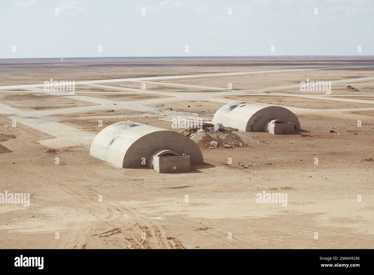 A view of damage to hardened aircraft shelters at Al-Salman Air Base ...