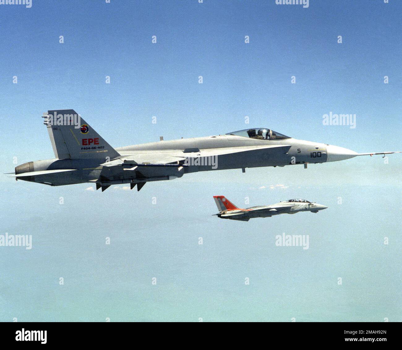 An air-to-air right side view of an F/A-18C Hornet aircraft, foreground ...