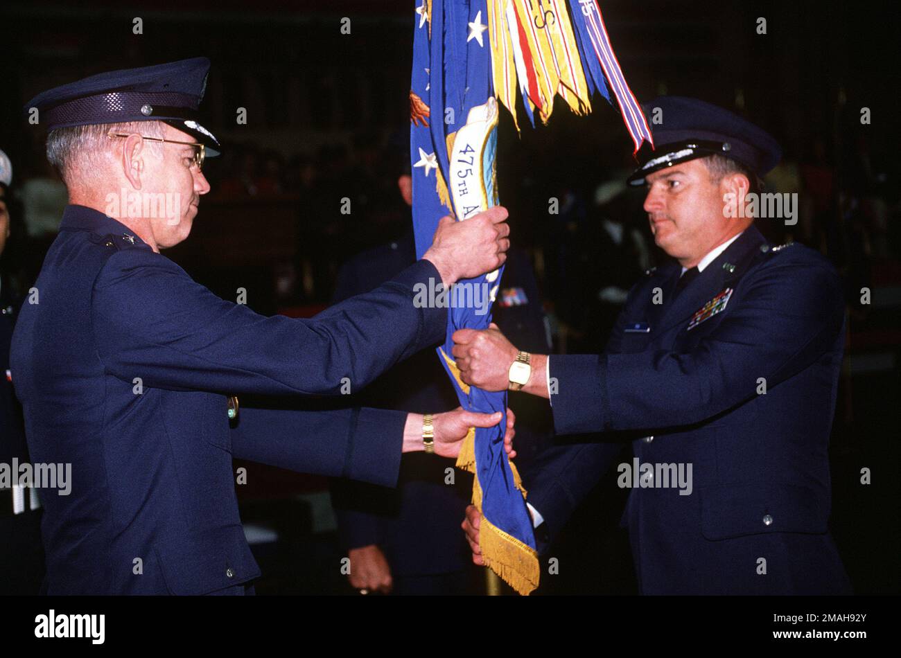 COL. Charles Fox, right, 475th Air Base Wing commander, passes the unit ...