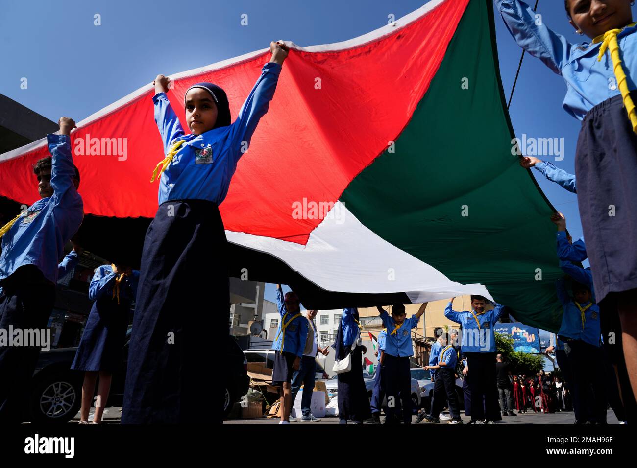 Palestinian scouts carry their national flag, as the march during the ...