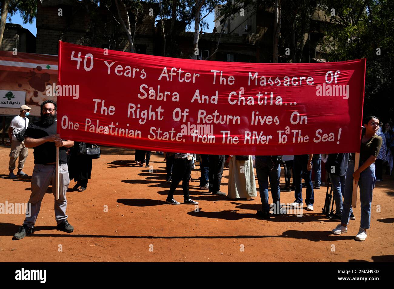 Palestinian activists hold a banner to commemorate the 40th anniversary ...