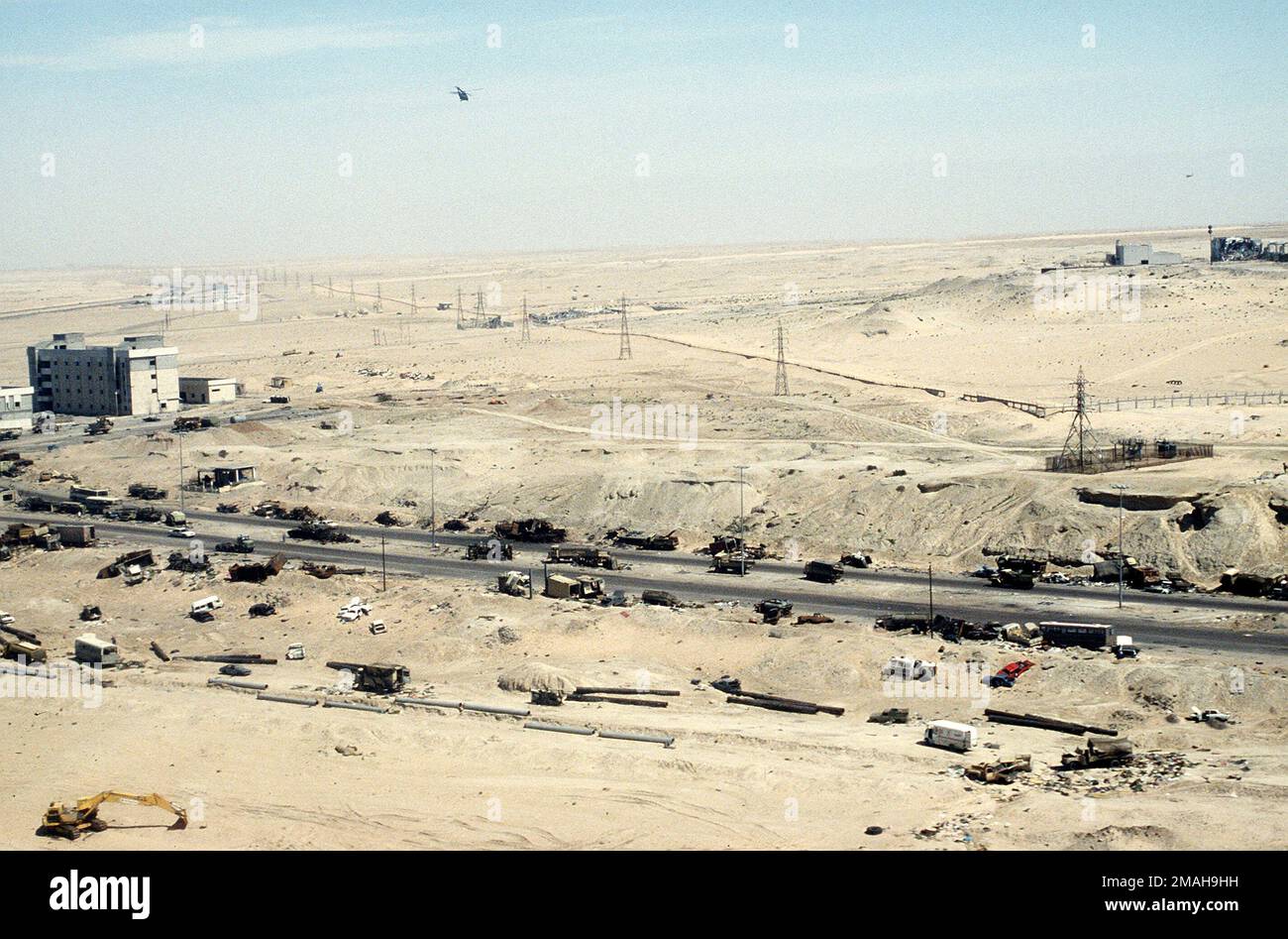 Demolished and abandoned vehicles line the highway en route to Basra in ...