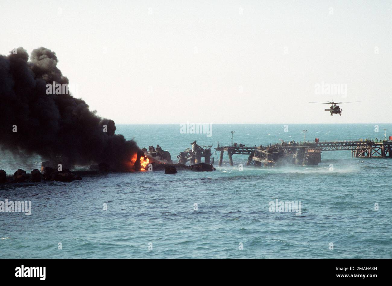Flames consume an oil pipeline after it was set on fire by Iraqi forces ...