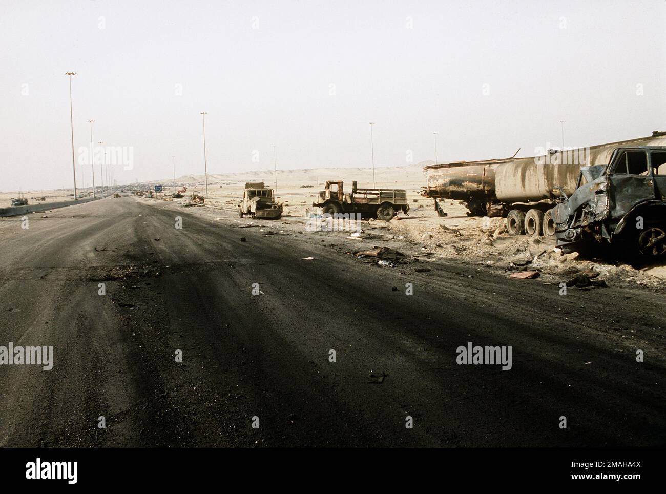 Demolished Iraqi vehicles litter the road to Basra after Allied bombing ...