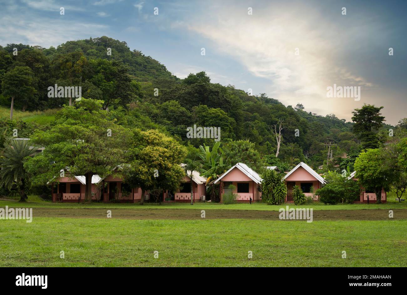 Small cute houses on tropical island Stock Photo - Alamy