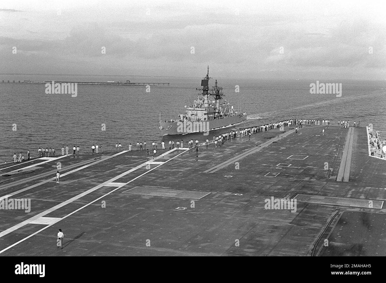 The guided missile cruiser USS JOSEPHUS DANIELS (CG-27) passes the ...