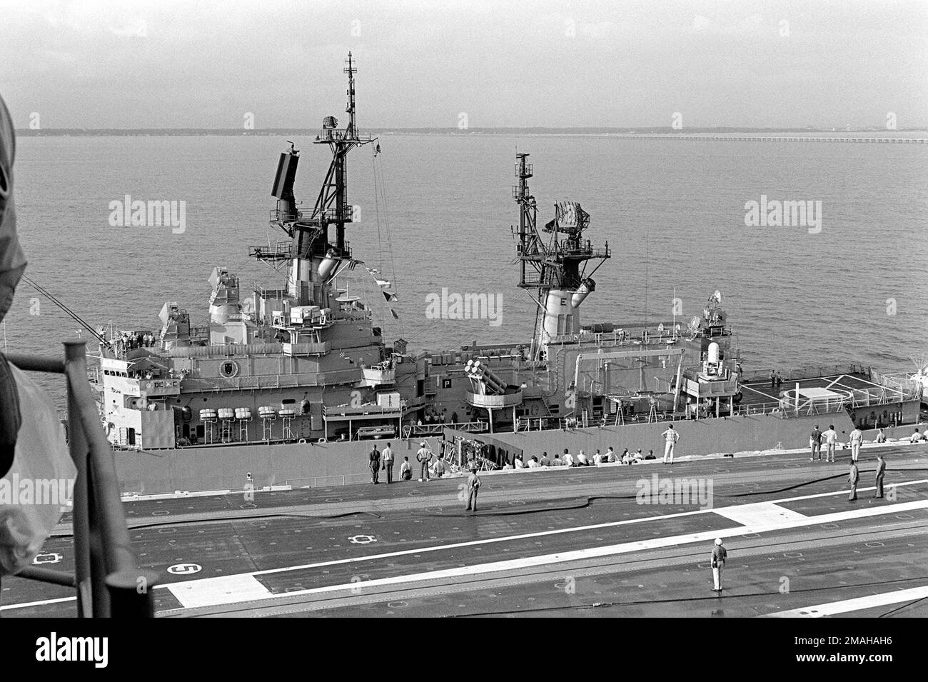 The guided missile cruiser USS JOSEPHUS DANIELS (CG-27) passes close to ...