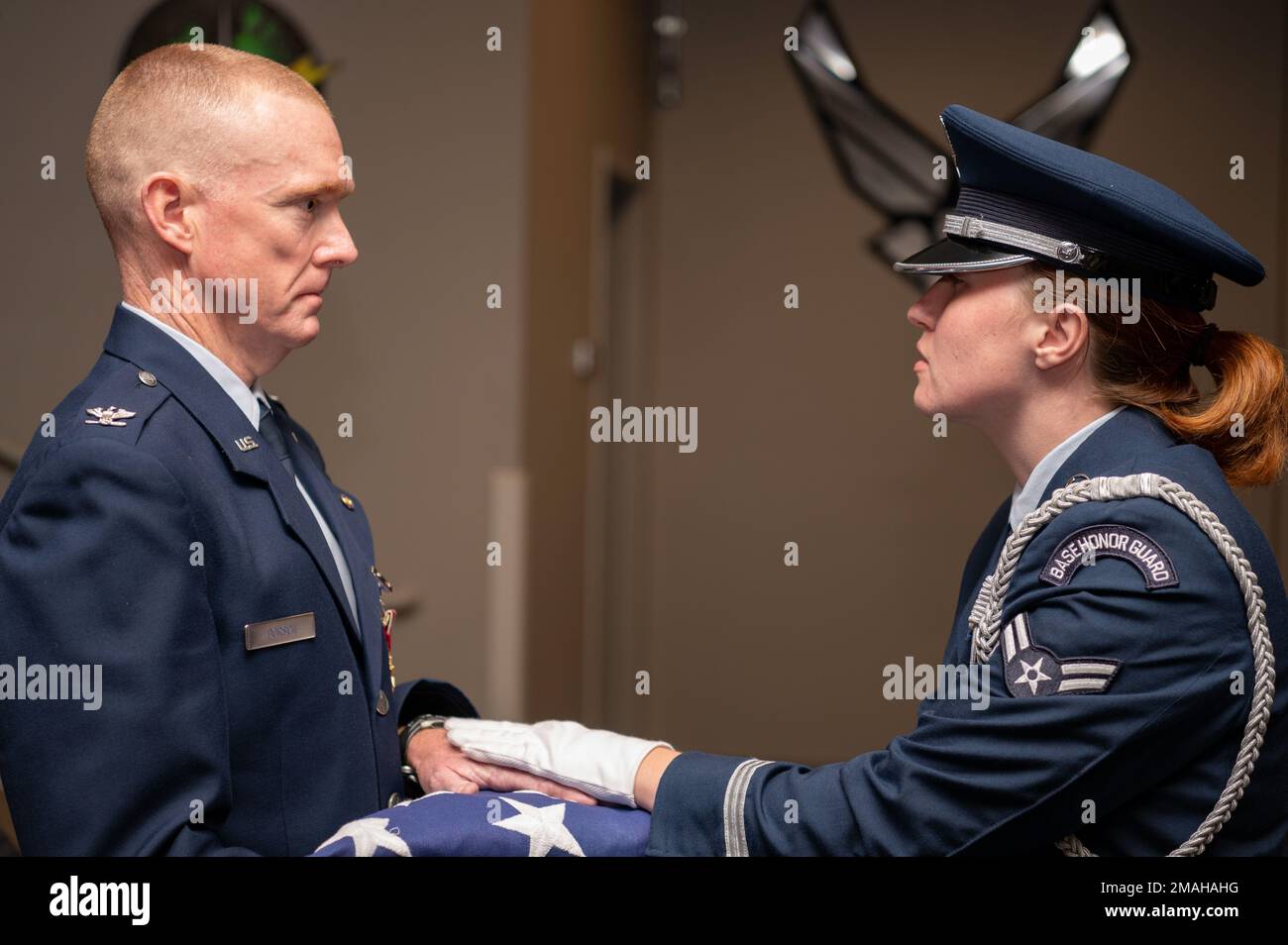 A U.S. Air Force Ceremonial Guardswoman presents the American flag to U ...