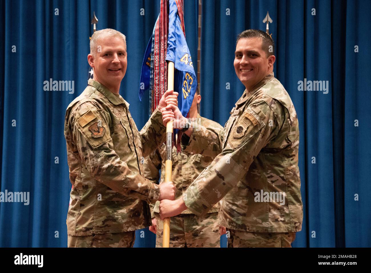 Lt. Col. Robert Switzer, right, receives a guidon from Col. Alan Berck ...