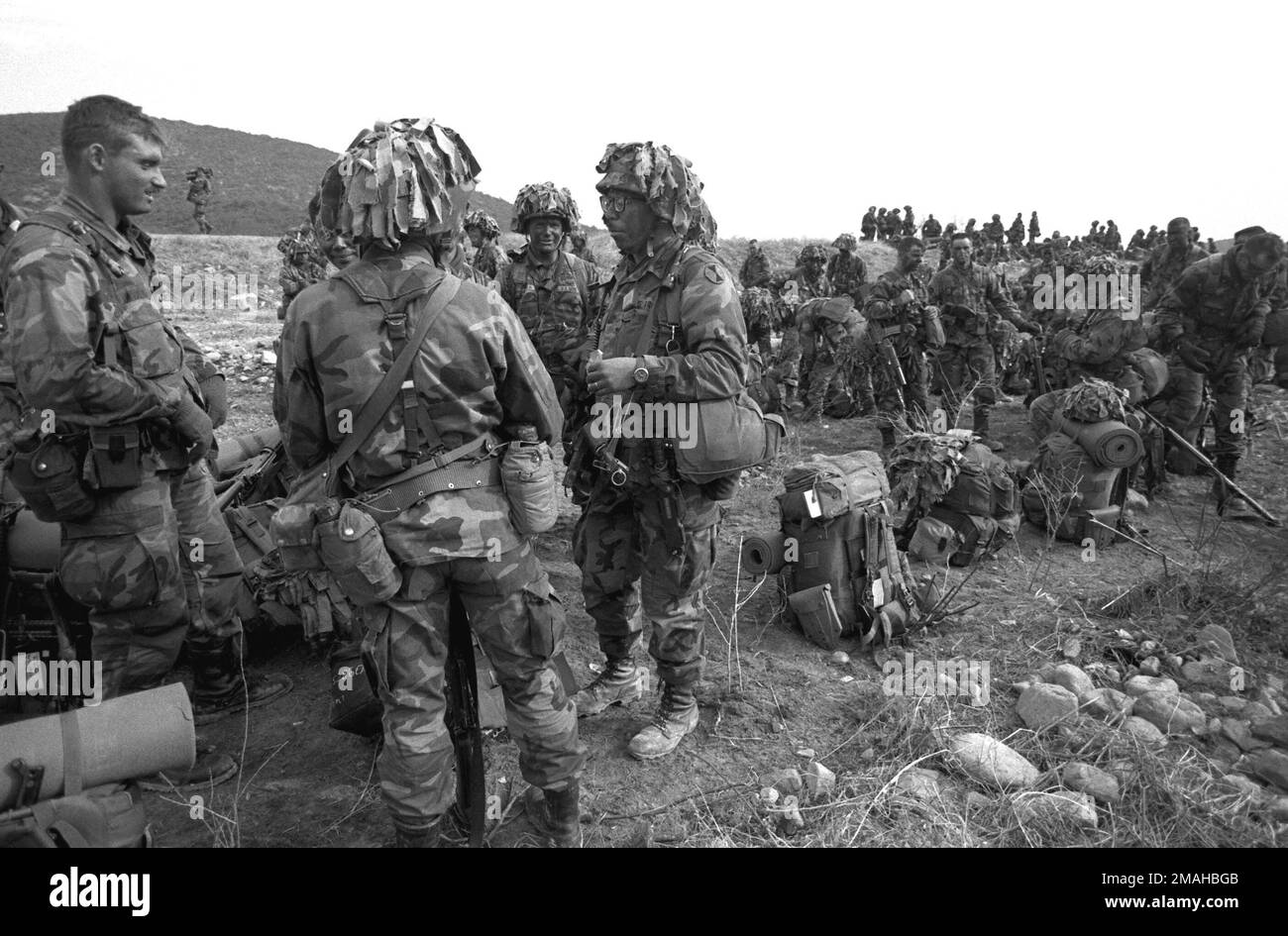 Members of the Army's 7th Infantry Division (Light) prepare to move on to their next objective ...