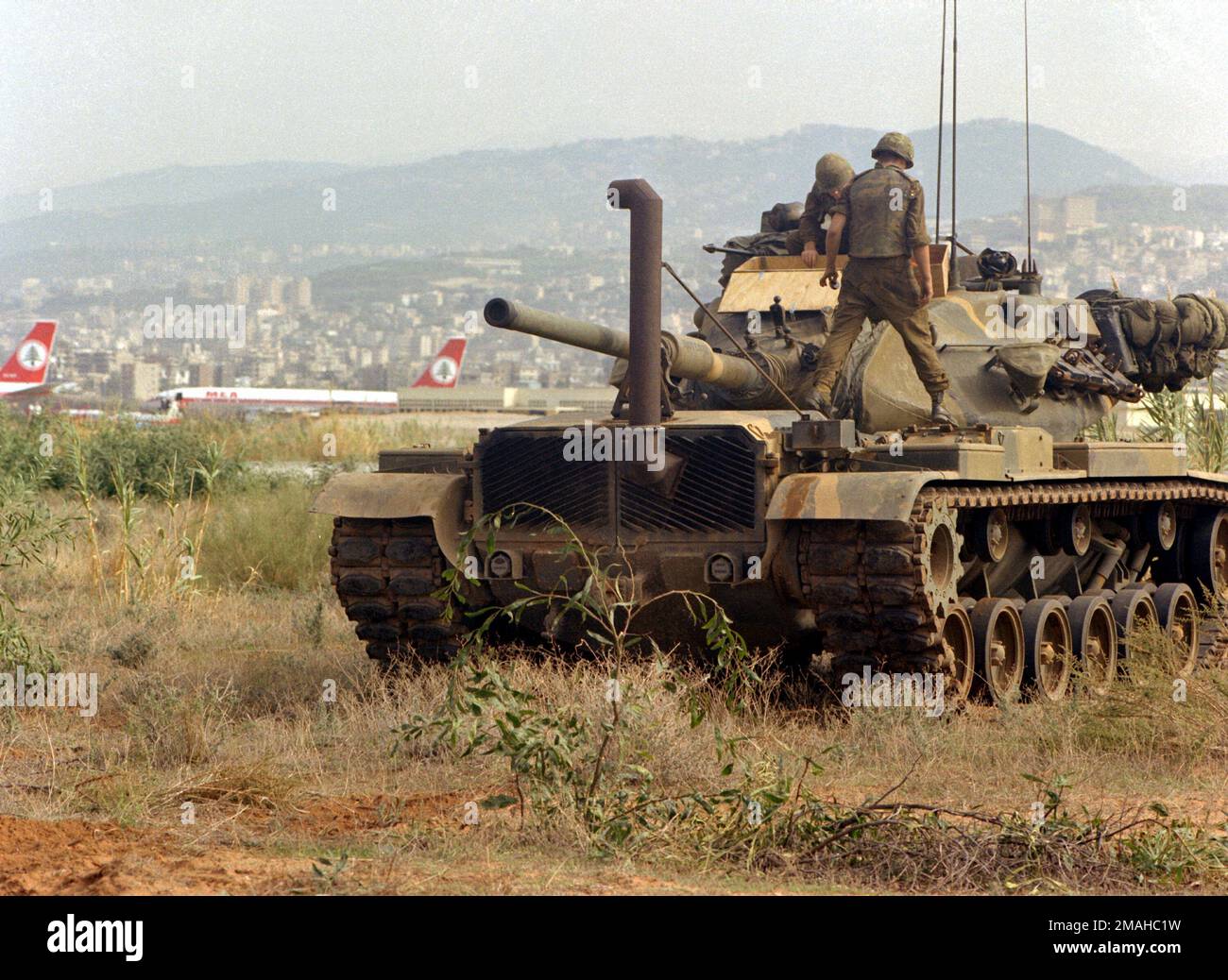 U.S. Marines man an M-60 main battle tank. The tank is guarding the ...
