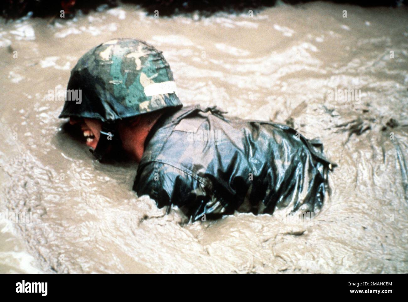 A Marine officer candidate from The Basic School, moves through a muddy ...
