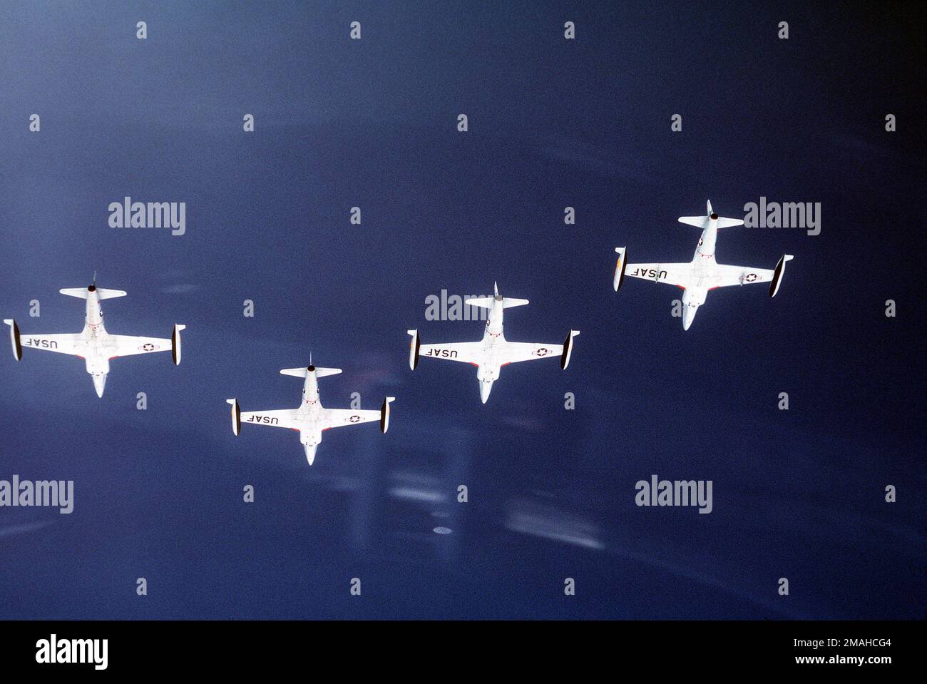 An air-to-air rear underside view of four T-33 Shooting Star aircraft ...