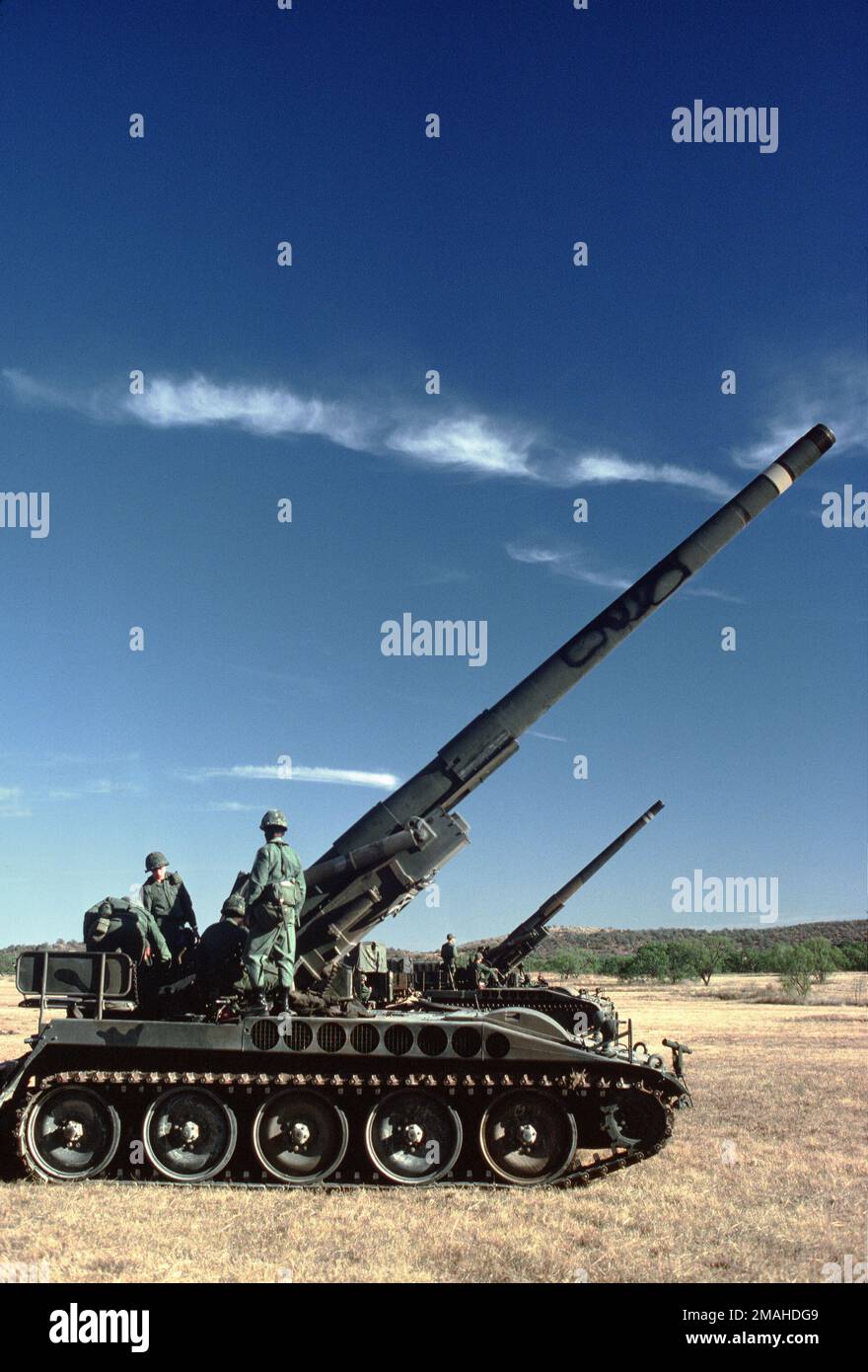 Ammunition is loaded into M107 175 mm self-propelled howitzers during a ...