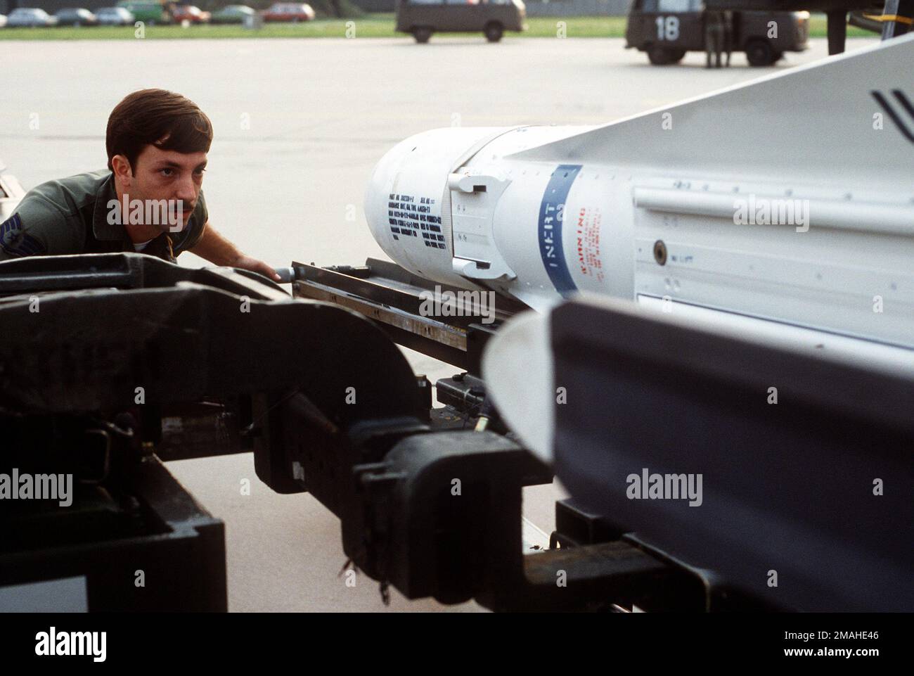 A ground crewman rearms an A-10 Thunderbolt II aircraft during Reforger ...