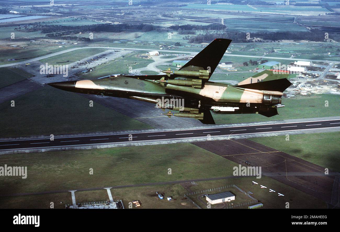 An air-to-air left underside view of an F-111 aircraft flown by the ...