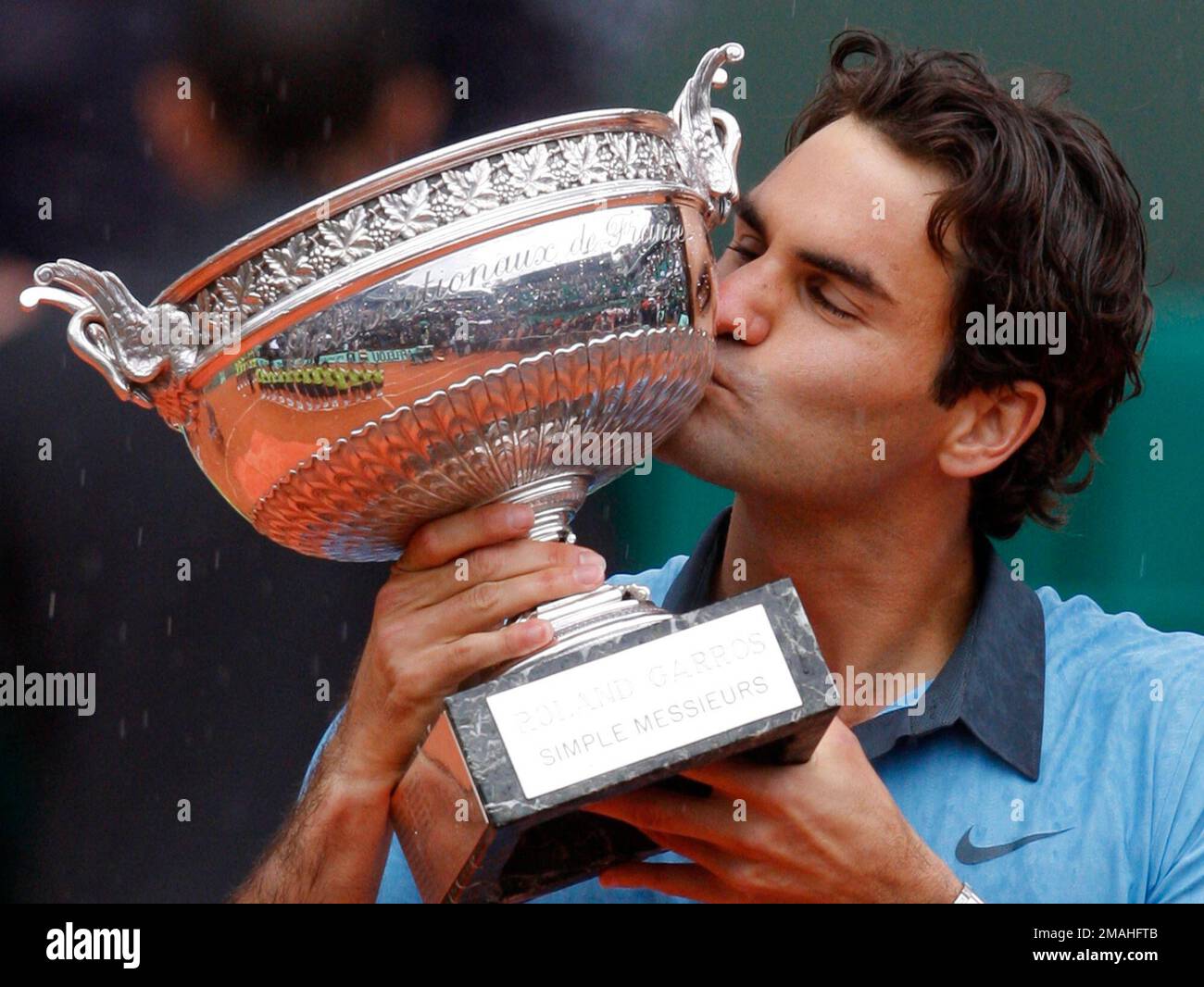 FILE - Switzerland's Roger Federer kisses his trophy after defeating ...