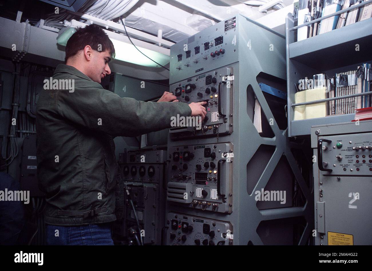A petty officer checks missile tracking system equipment during a ...