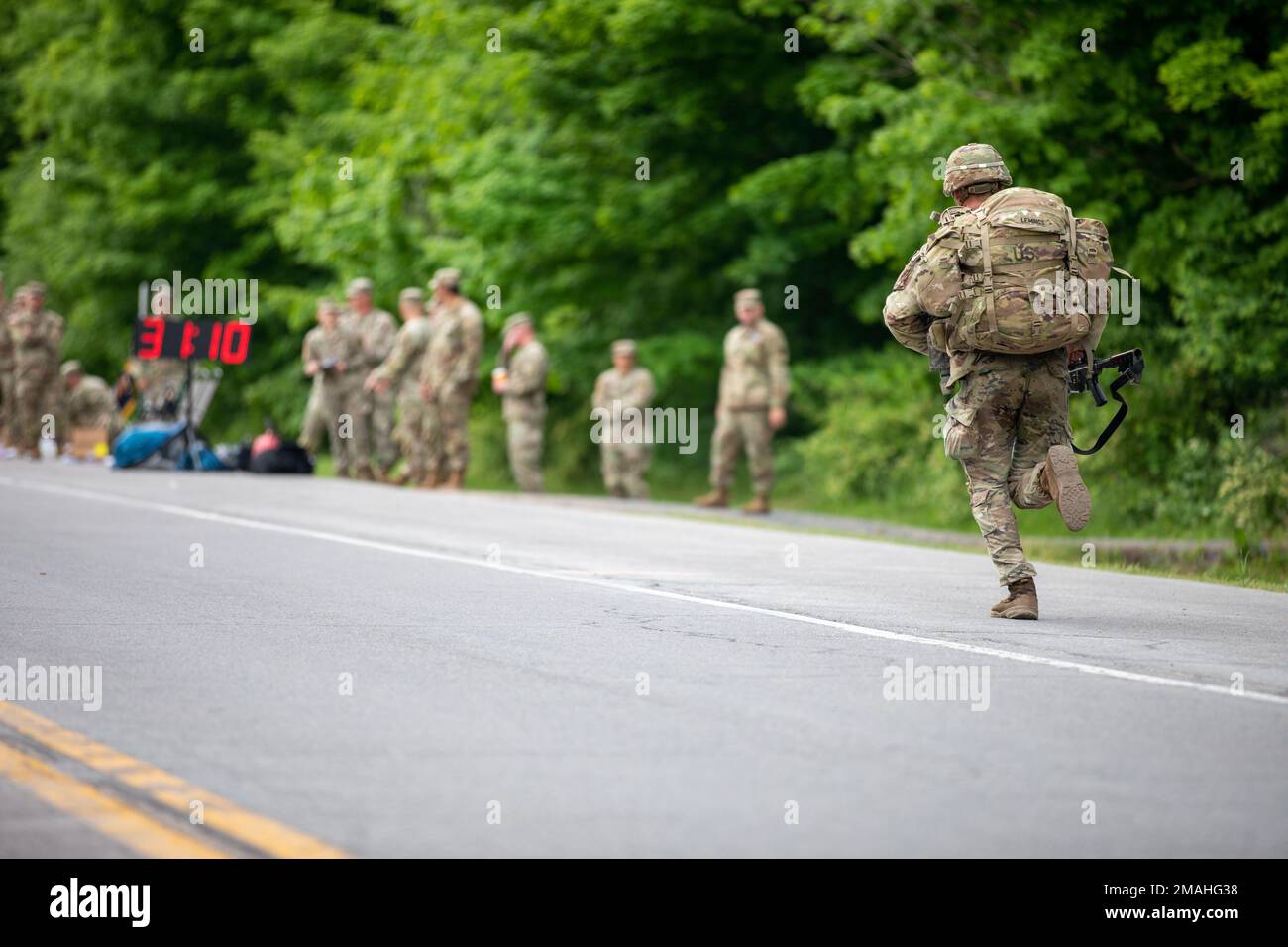 Soldiers with 10th Mountain Division complete a ruck march as part of ...