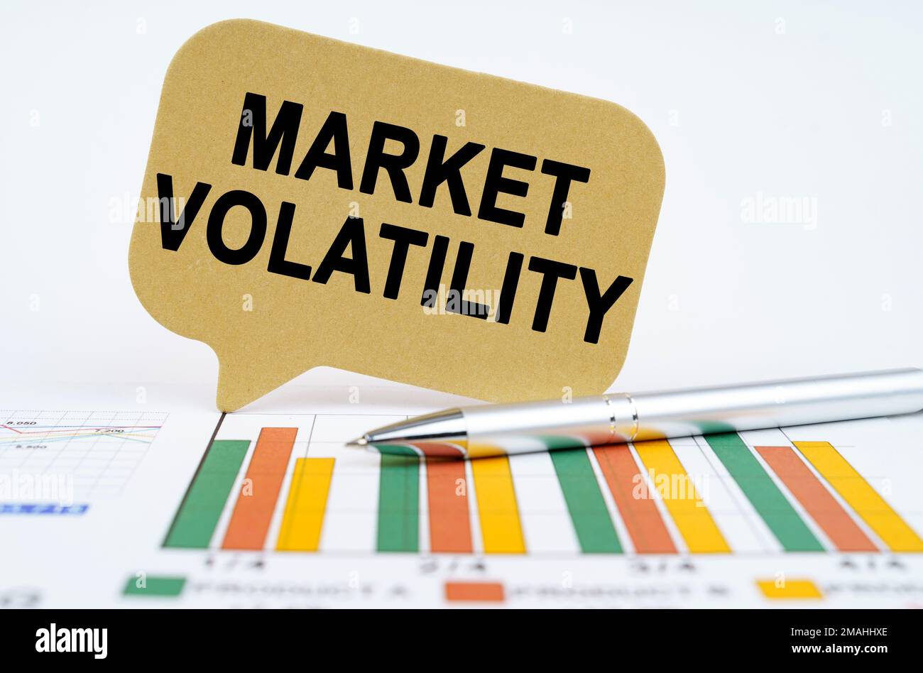 Business concept. On the financial charts lies a pen and a sign with ...