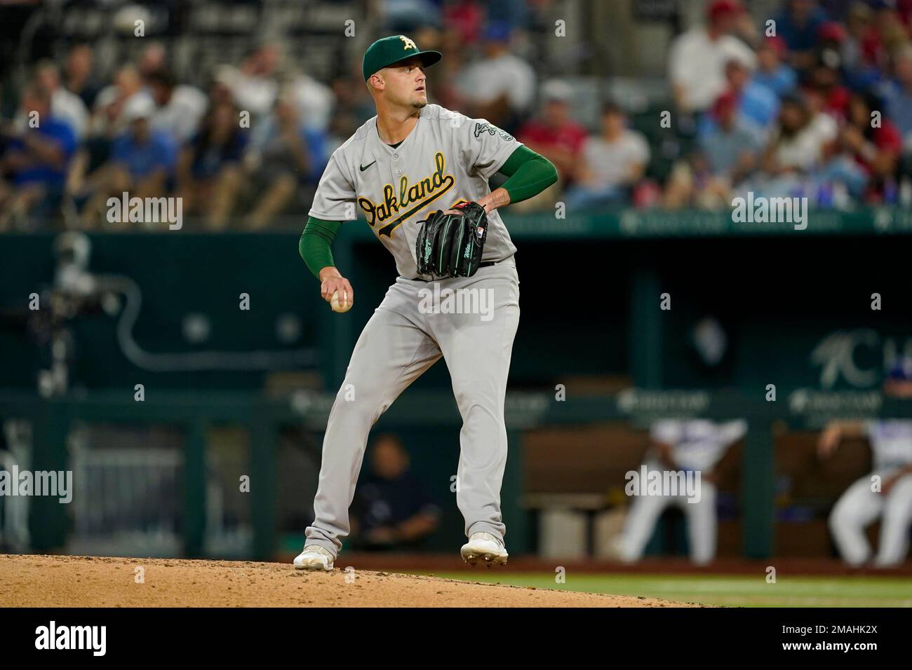 Oakland Athletics relief pitcher Collin Wiles winds up to deliver to ...