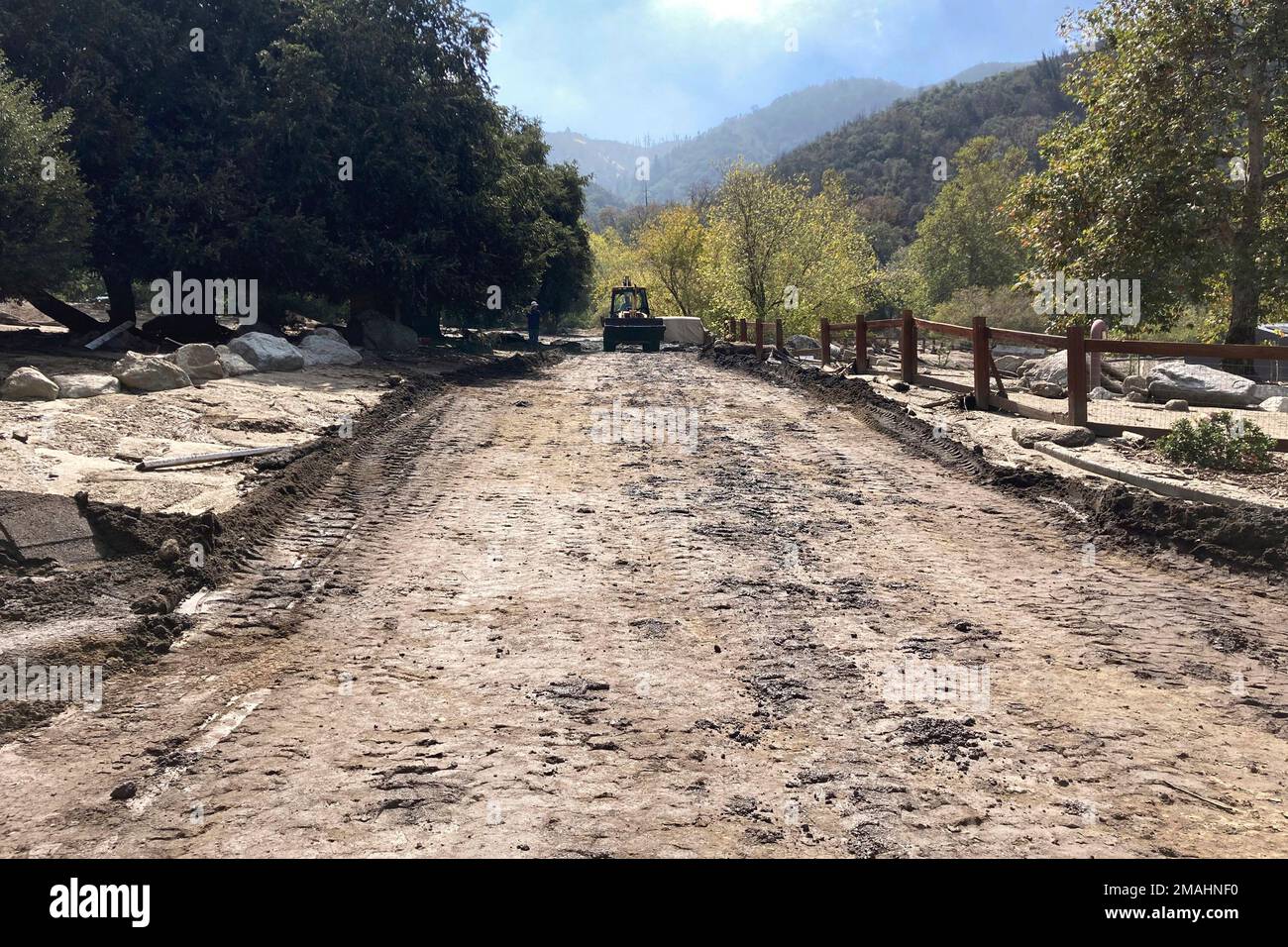 Debris from the aftermath of a slow-moving black river of sludge is ...
