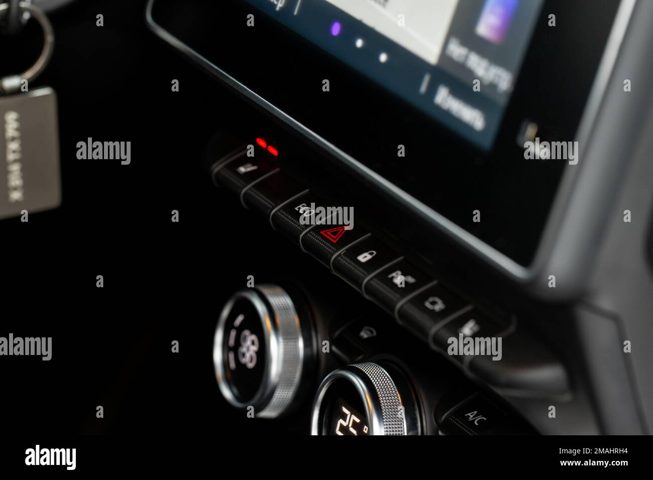 Red triangle hazard light button on car dashboard. Car media buttons ...
