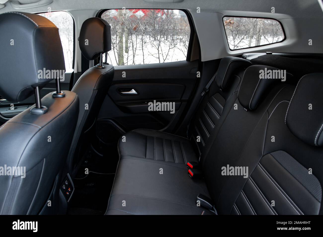 Modern car interior. Clean rear seats with the belts. Three rear seats ...