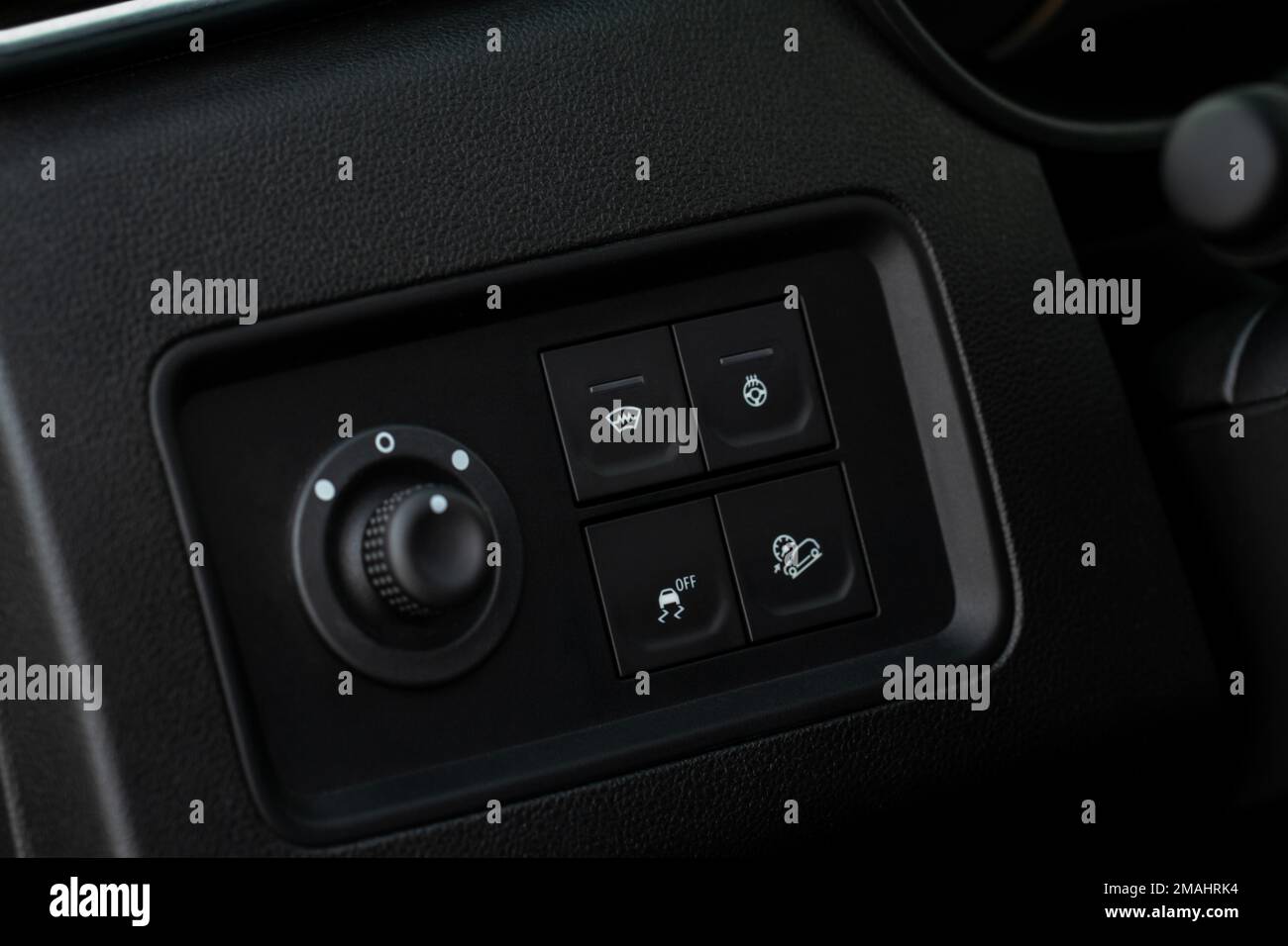 Hand operating ESP (electronic stability program) control close up view ...