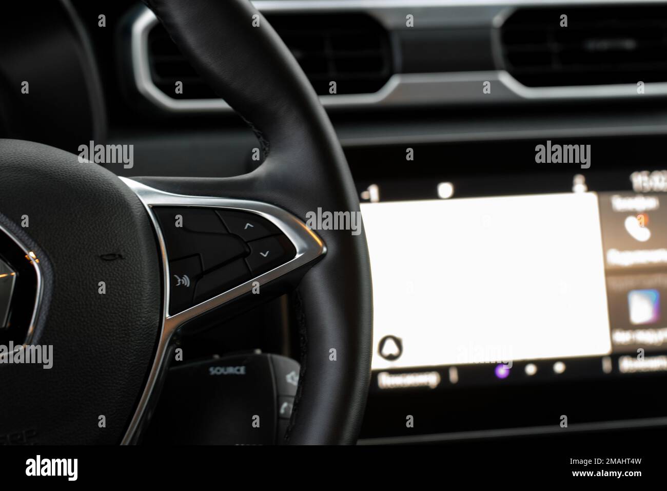 Volume and audio control buttons on the steering wheel. Car audio ...