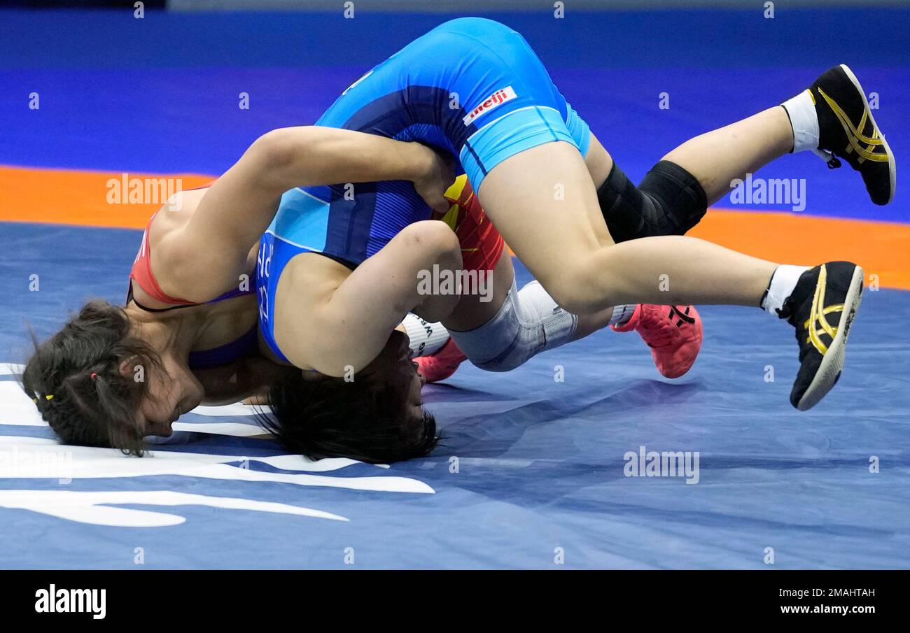 Japan's Sakura Motoki, front, and Moldova's Anastasia Nichita compete ...