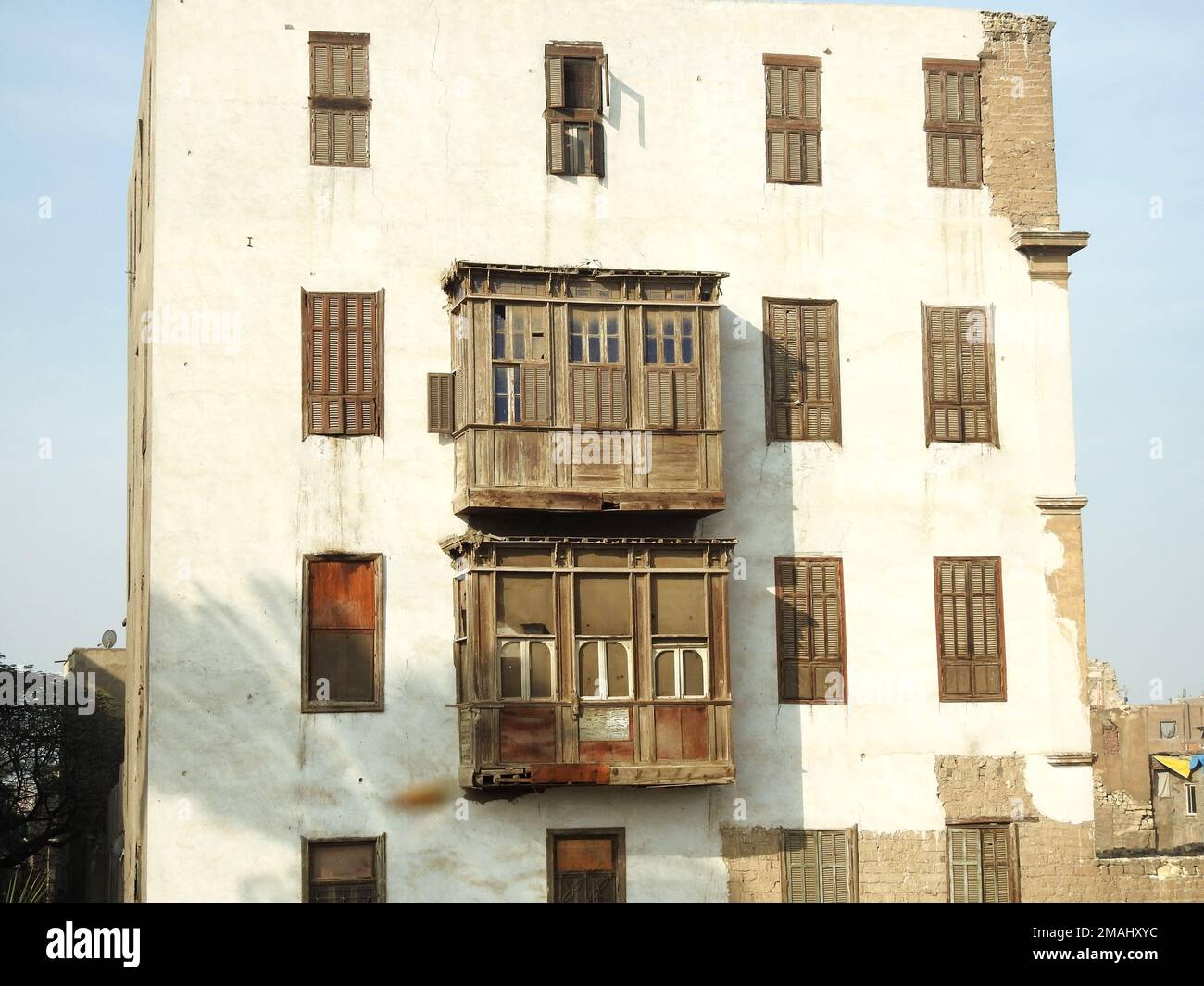 An old vintage retro building with old stye wooden balcony and windows ...