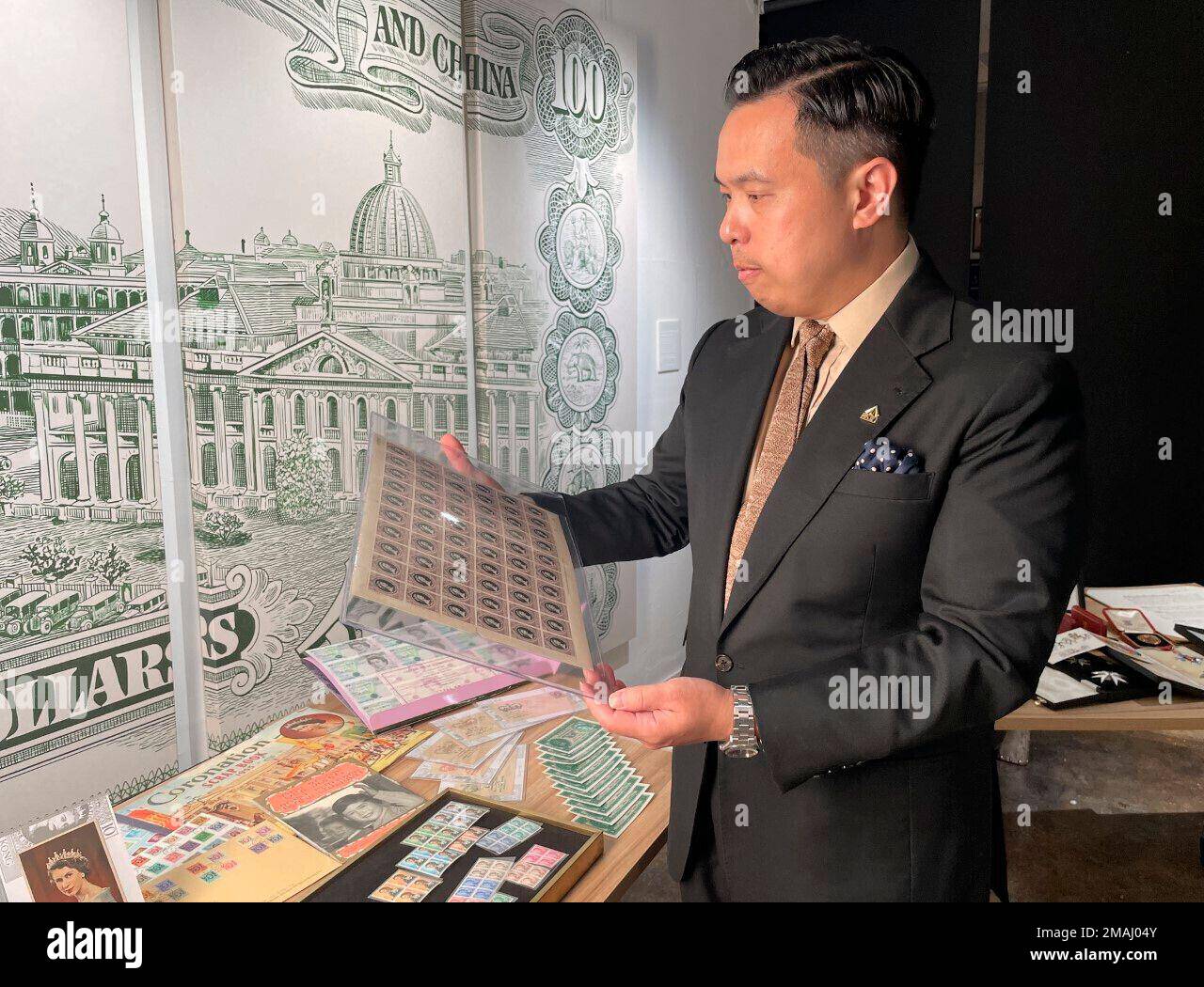 Museum owner Bryan Ong looks at old postage stamps from British Hong ...