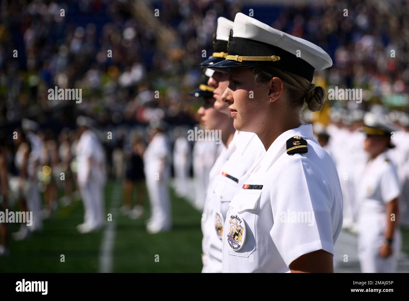 The brigade of midshipmen march on the field before an NCAA college ...
