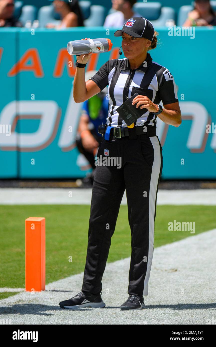 NFL down judge Robin DeLorenzo drinks water on the field during an NFL ...