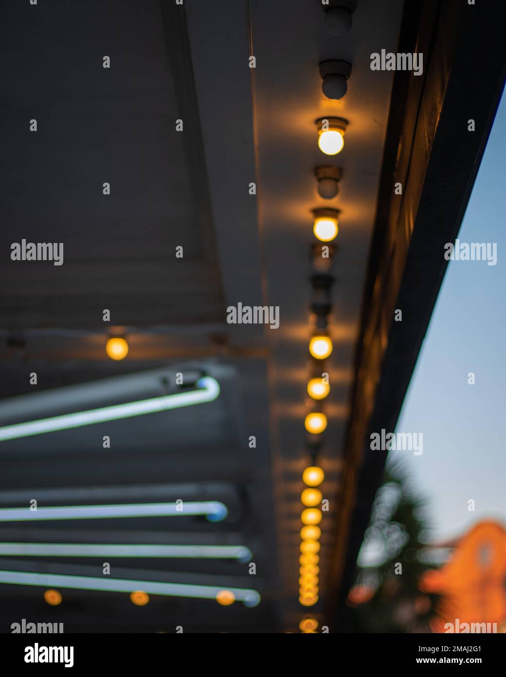 Round yellow lights attached to the ceiling of an entrance to a theater ...